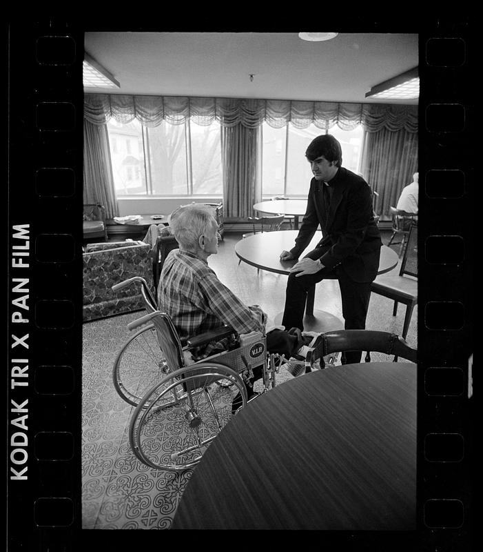 Young priest at home for elderly, Chelsea - Digital Commonwealth