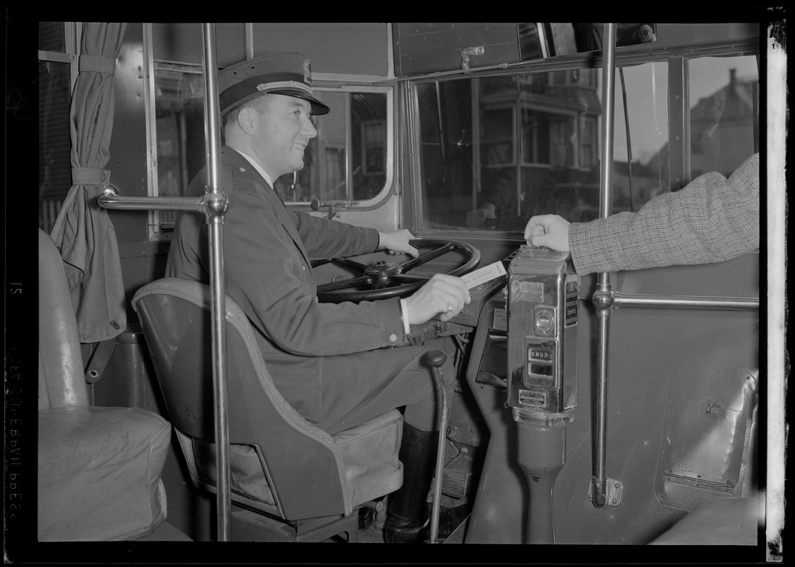 Man paying bus fare next to bus driver - Digital Commonwealth