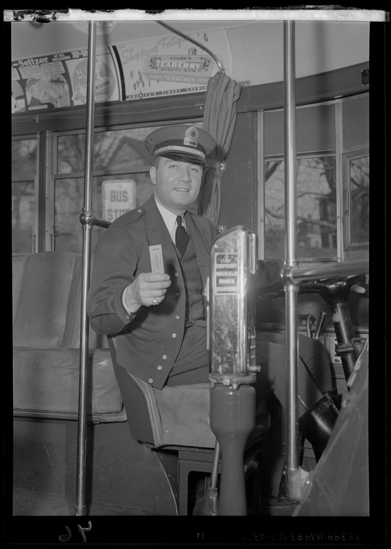 A bus driver behind the wheel of a bus - Digital Commonwealth