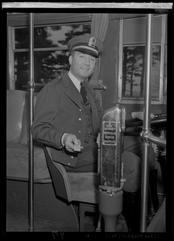 A bus driver behind the wheel of a bus - Digital Commonwealth