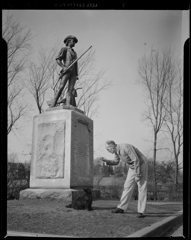 Cedric Foster playing with dog in front of Minute Man statue - Digital ...