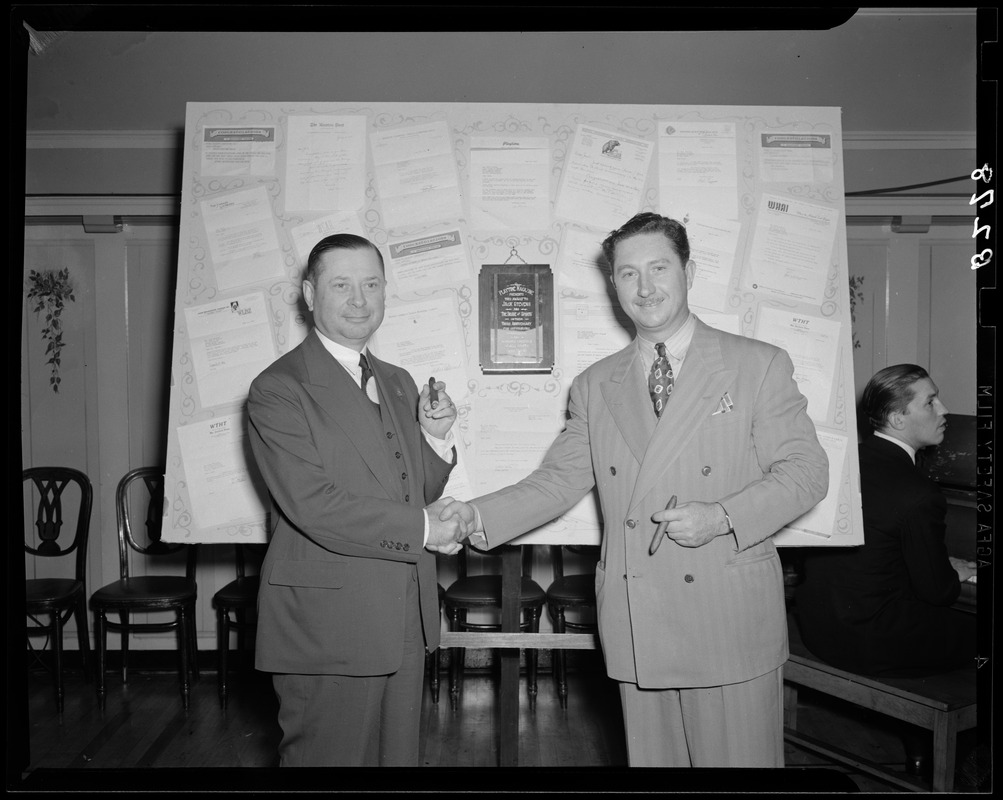Jack Stevens standing in front of award - Digital Commonwealth