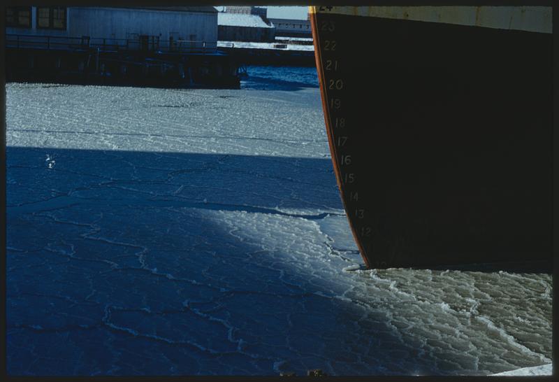 Draft marks on bow of ship in icy waters - Digital Commonwealth