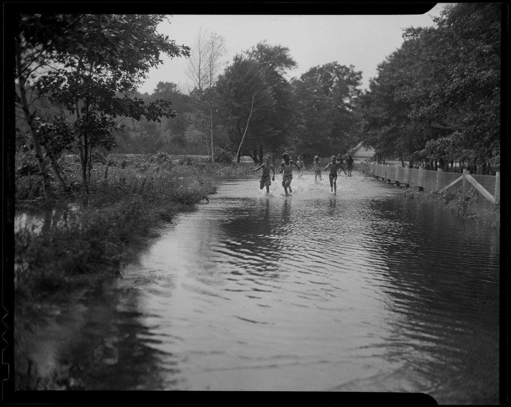 Children running through flooded road - Digital Commonwealth