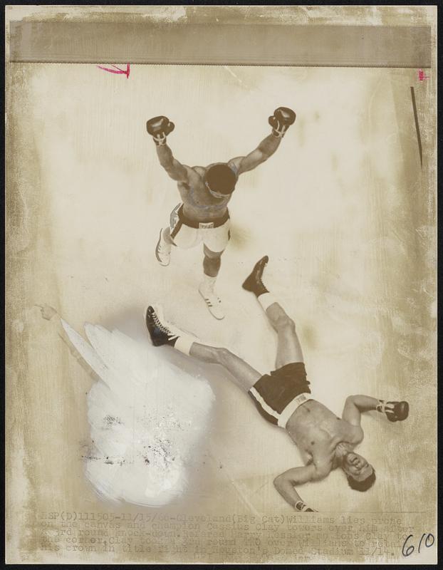 Cleveland (Big Cat) Williams lies prone on the canvas and champion ...