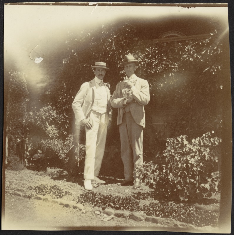Two well-dressed gentlemen standing in garden - Digital Commonwealth
