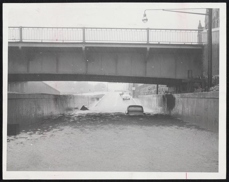 Flooded Underpass - A late model car sits stalled in two feet of water ...