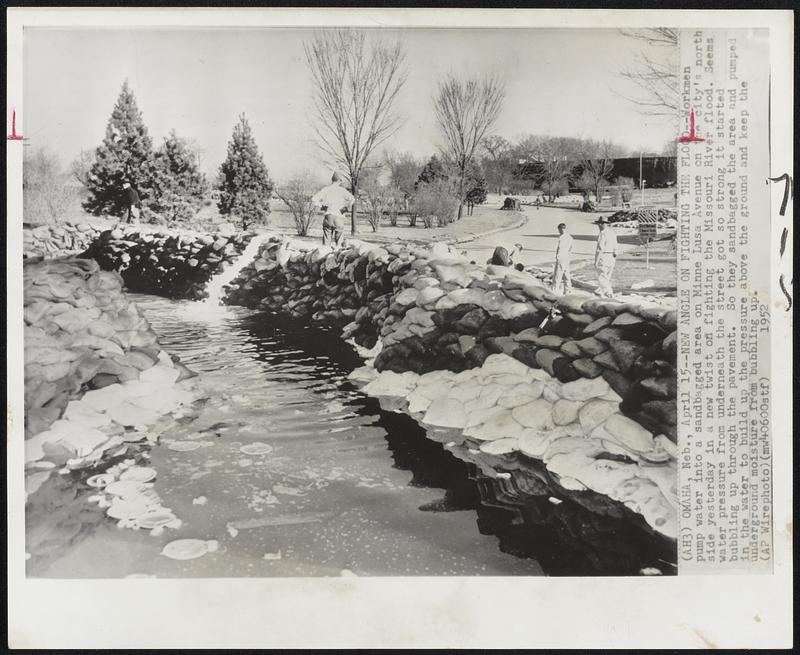 New Angle on Fighting the Flood -- Workmen pump water into a sandbagged ...