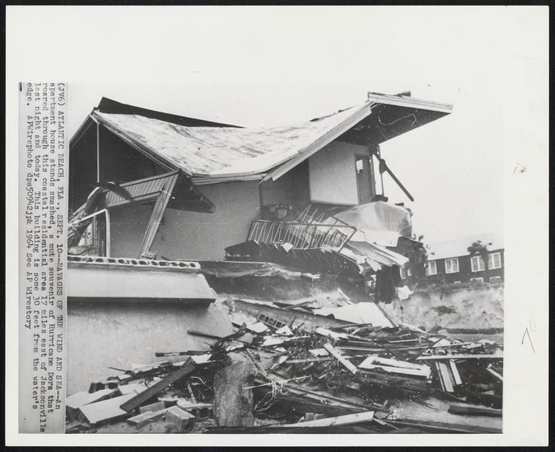Ravages of the Wind and Sea--An apartment house stands smashed, a mute ...