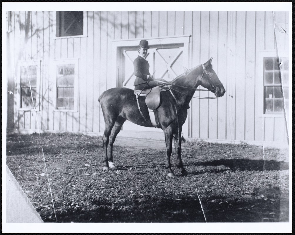 Miss Kate Cary: on horseback in front of barn door - Digital Commonwealth