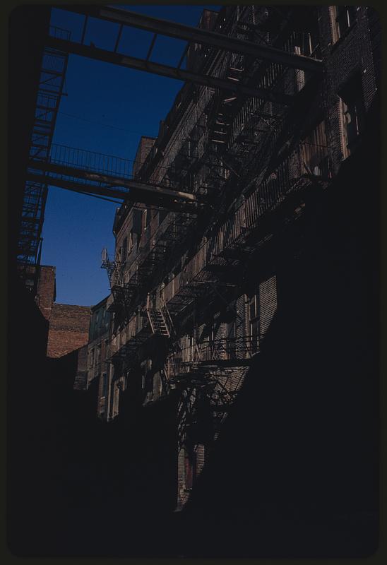 Buildings with elevated walkways and fire escapes - Digital Commonwealth