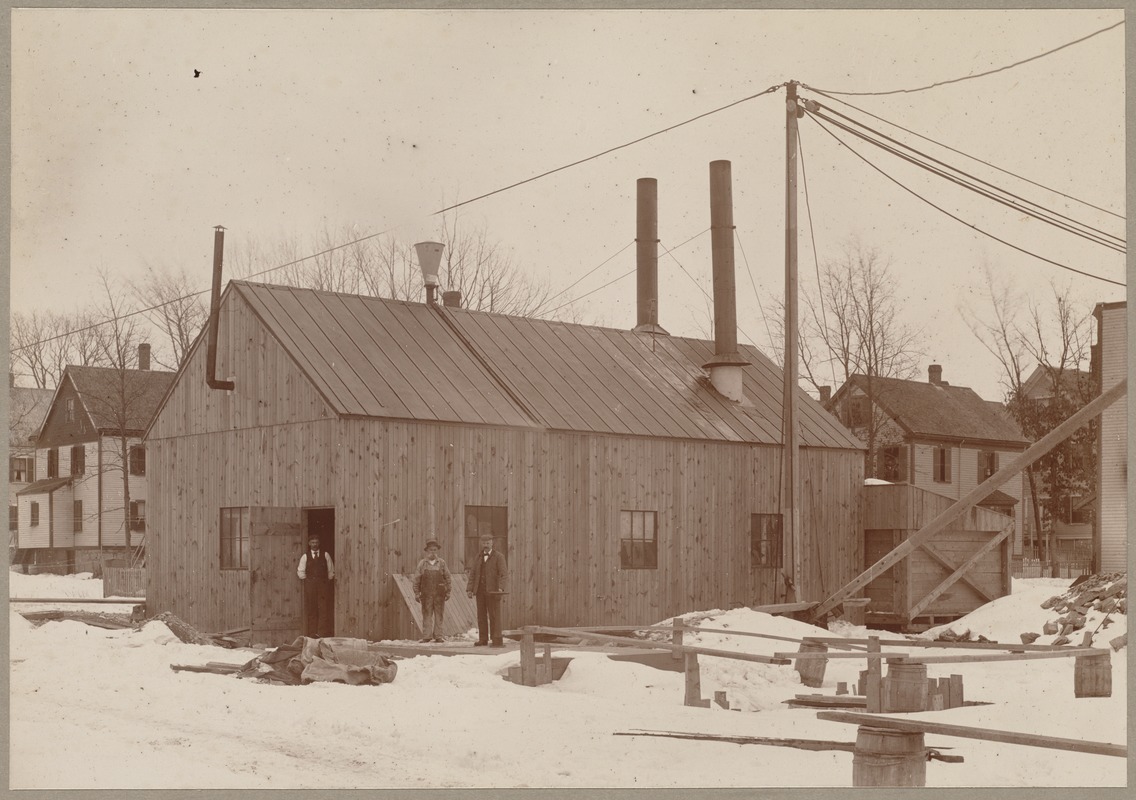 Men standing outside of building in snow - Digital Commonwealth