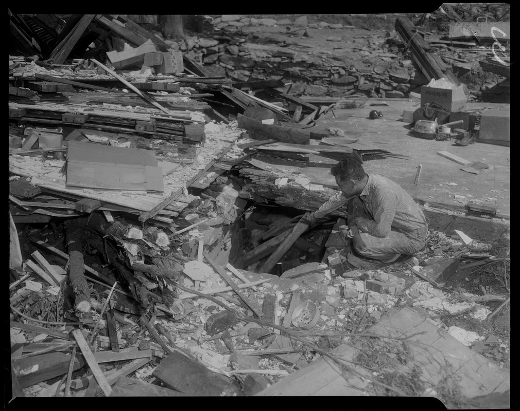 Man combing through wreckage - Digital Commonwealth
