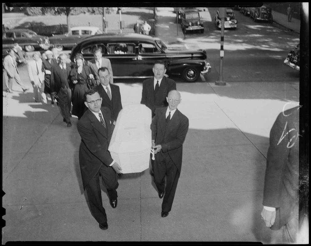 Four men carrying coffin, with other people following - Digital ...