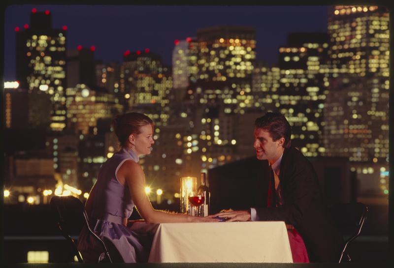 Romantic dinner with ring against the backdrop of the Boston skyline ...