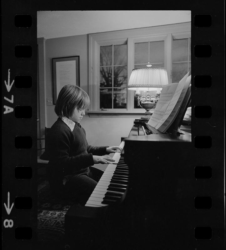 Bruce Irving's child playing the piano - Digital Commonwealth