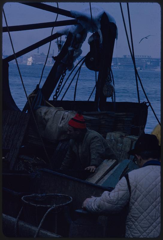 Men on a boat in dim lighting - Digital Commonwealth