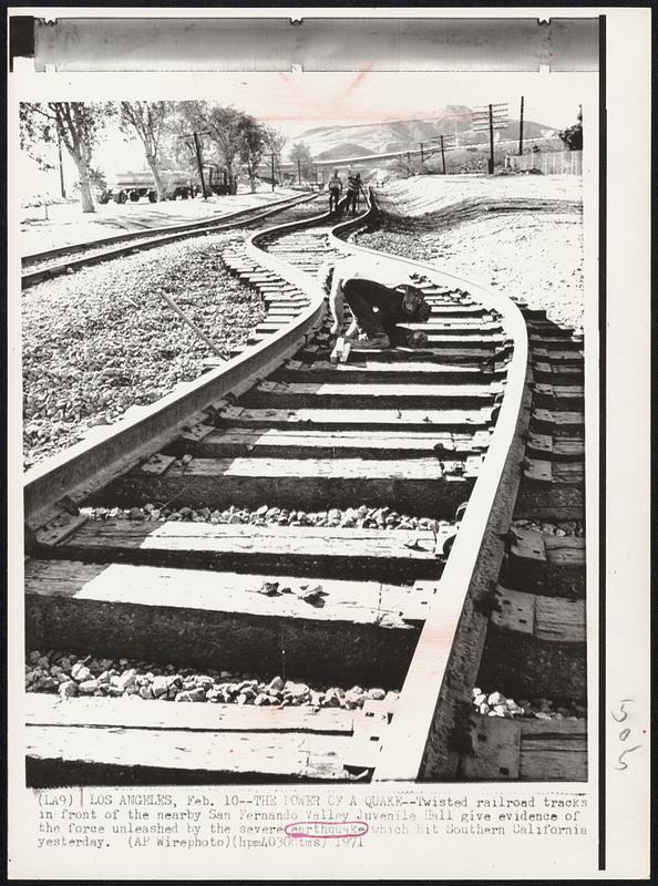 The Power of a Quake -- Twisted railroad tracks in front of the nearby ...