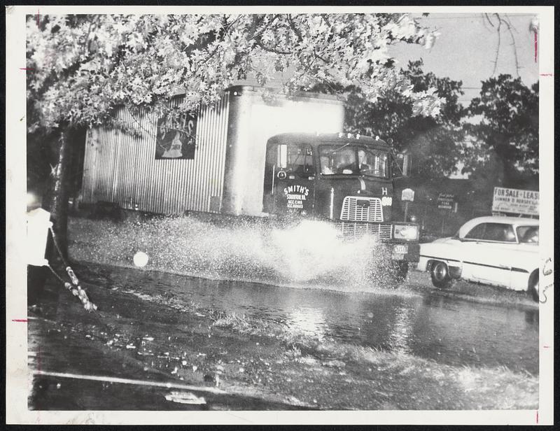 Truck Plows through flooded section of Rte. 9 at Oak St., Natick, as ...