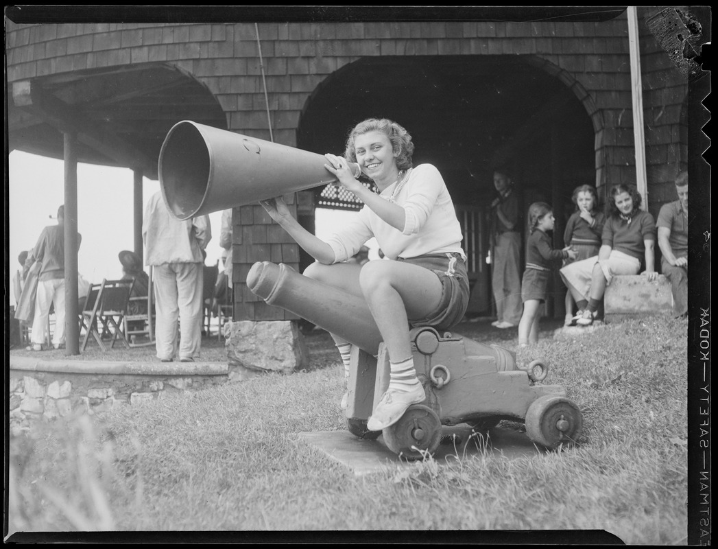 Woman with bullhorn astride starting cannon - Digital Commonwealth