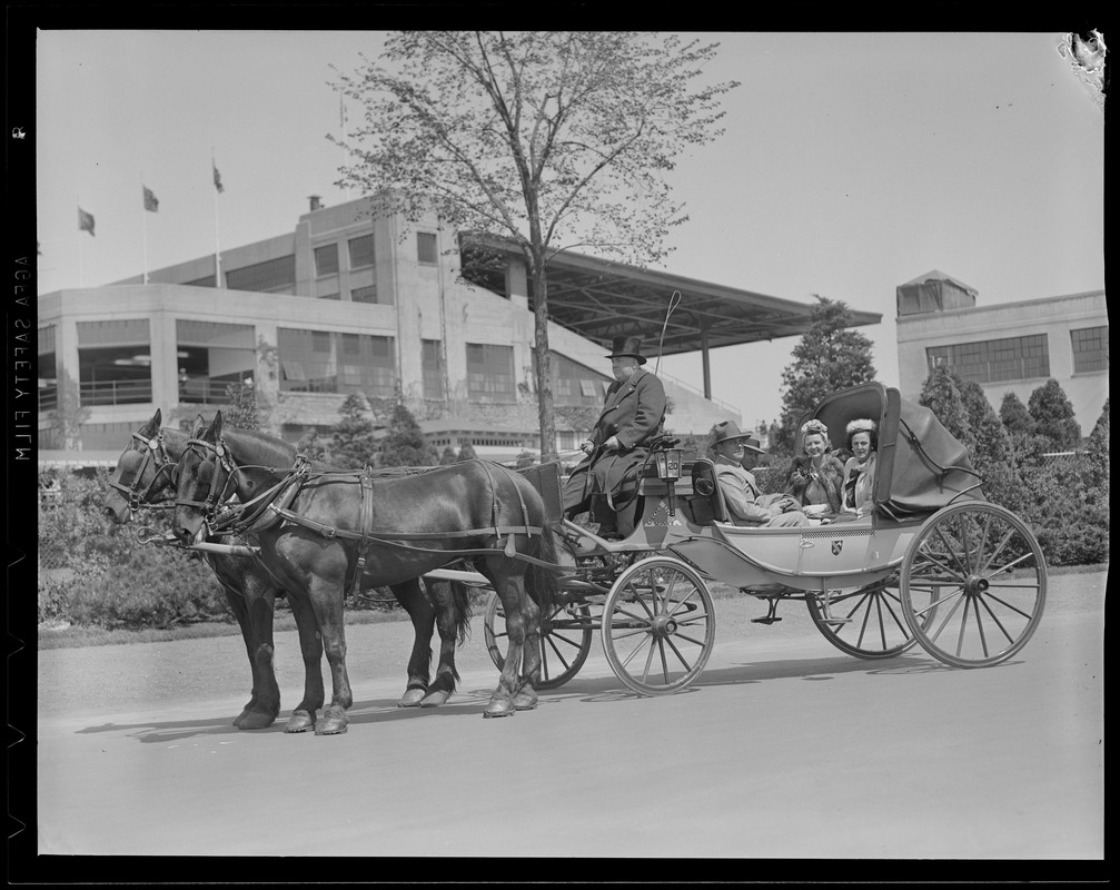 Couples ride in Checker livery service carriage, near Suffolk Downs ...
