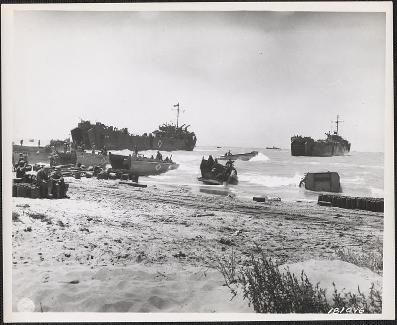 USS LST-344 at left, along with numerous LCVPs from transports anchored ...