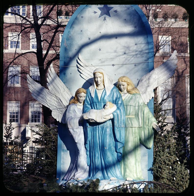 The Virgin Mary holding baby Jesus with two angels looking over her ...
