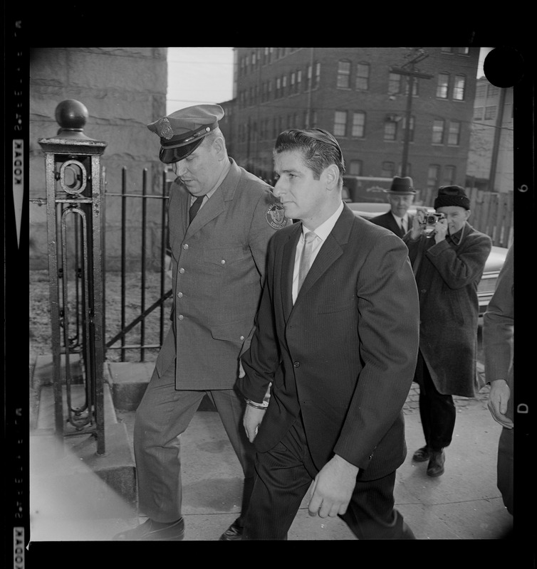 Guard Brauni Norkus walking with Albert DeSalvo - Digital Commonwealth