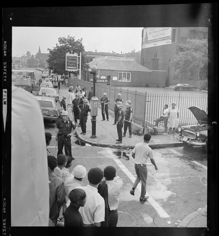 Police and the crowd at an intersection, looking towards National ...
