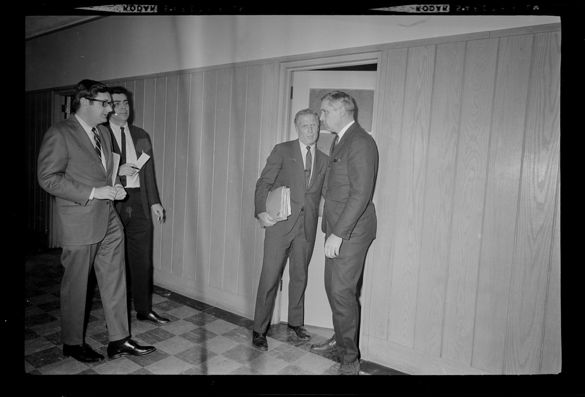 Mayor Kevin White walks out of a room and joins three other men in a ...