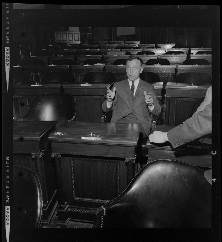 Representative H. Thomas Colo, seated, and talking to someone off ...