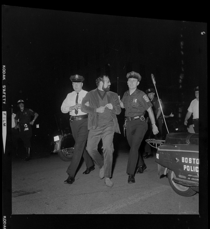 Two policemen take hold of a demonstrator with a beard out - Digital ...