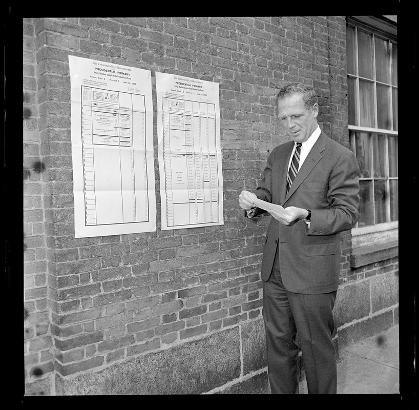Boston Mayor Kevin White examines Democratic ballot mounted on wall at ...