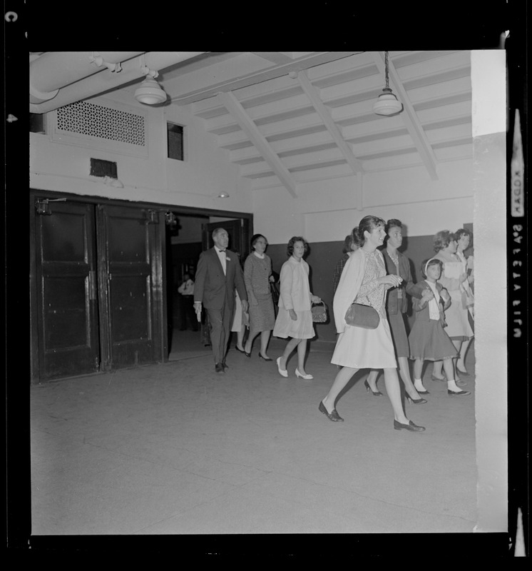 Spectators walking through the concourse of Boston Garden to hear ...