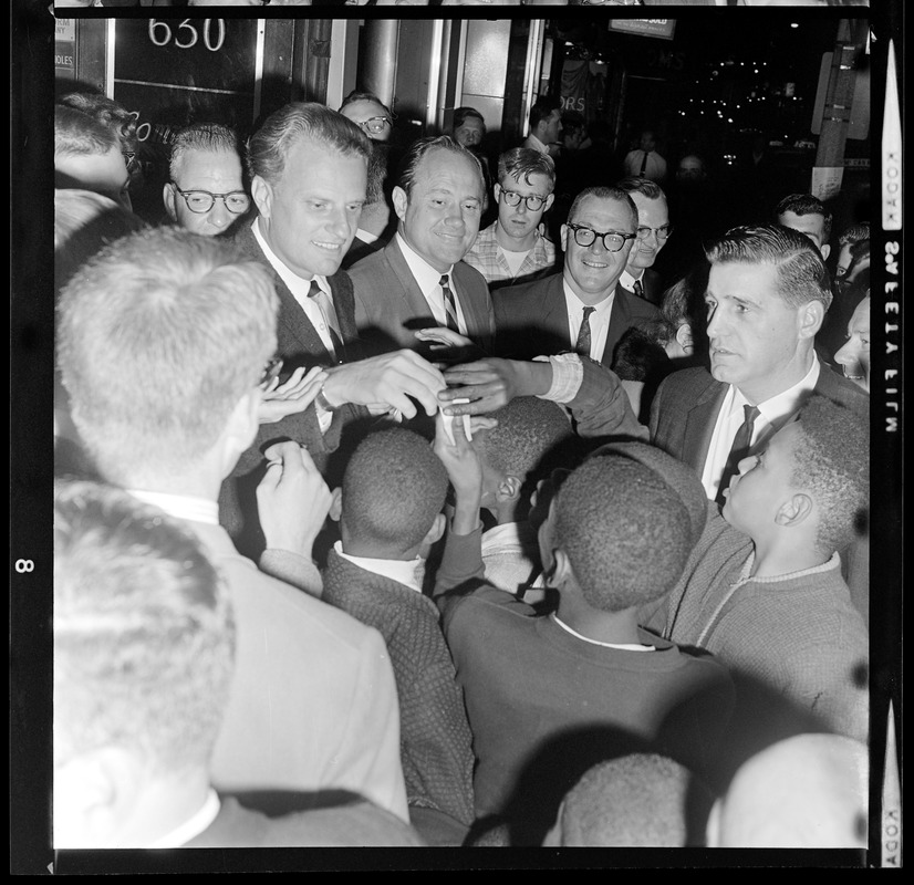 People reaching out to get an autograph from evangelist Dr. Billy ...