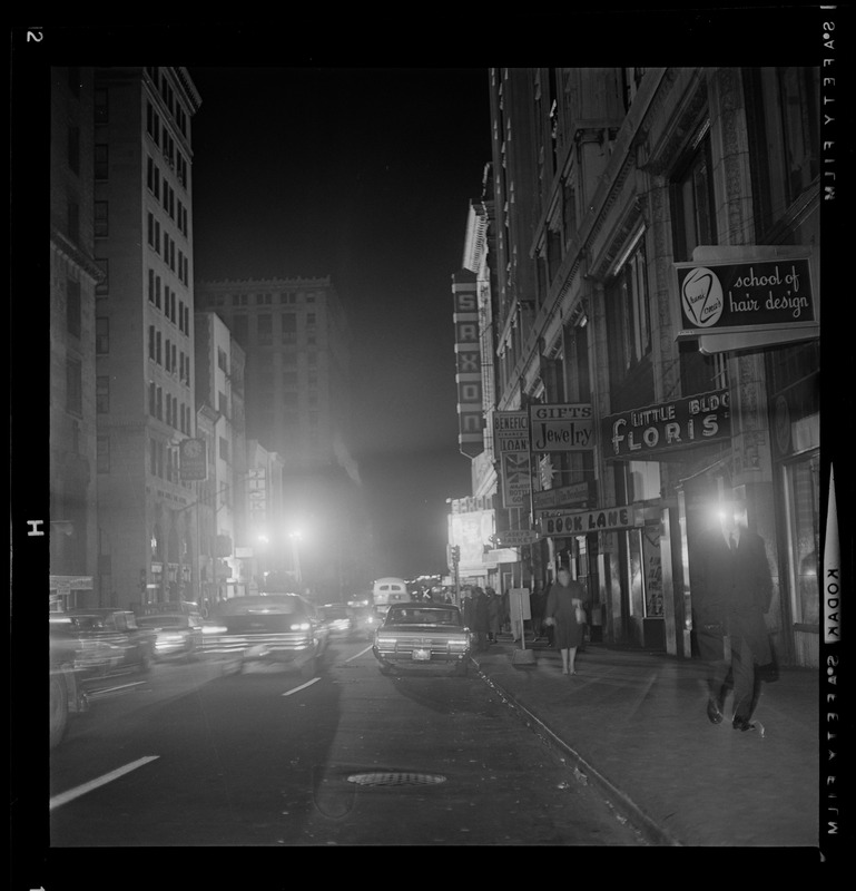 View of a street during blackout with pedestrians and cars parked on ...