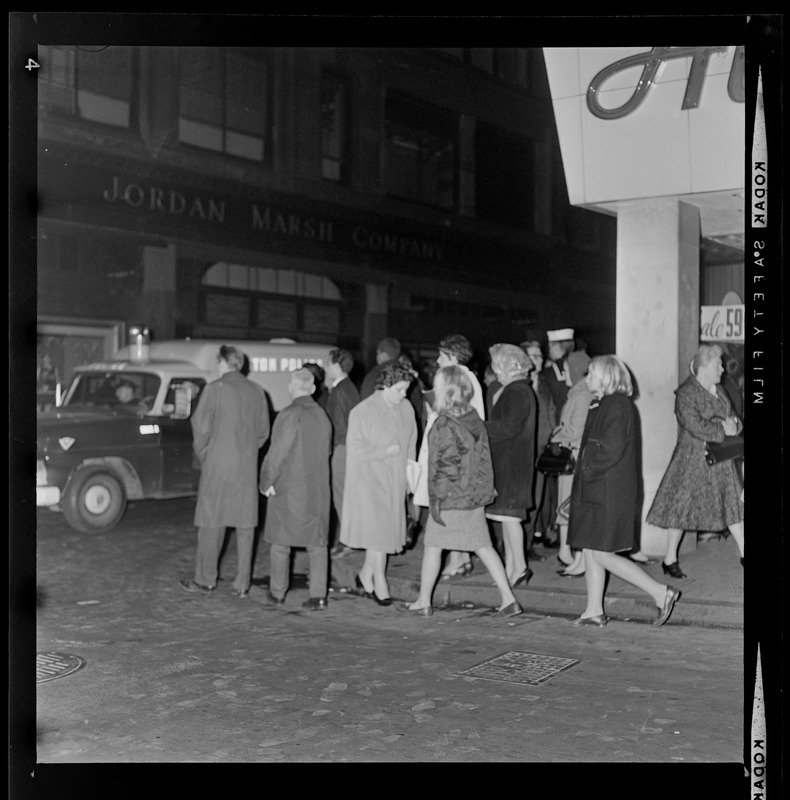 Group of people gathered on a corner across from Jordan Marsh during ...