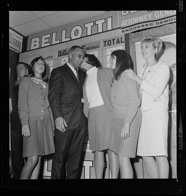 Former Lt. Gov. Francis Bellotti receives a kiss from a woman on stage ...