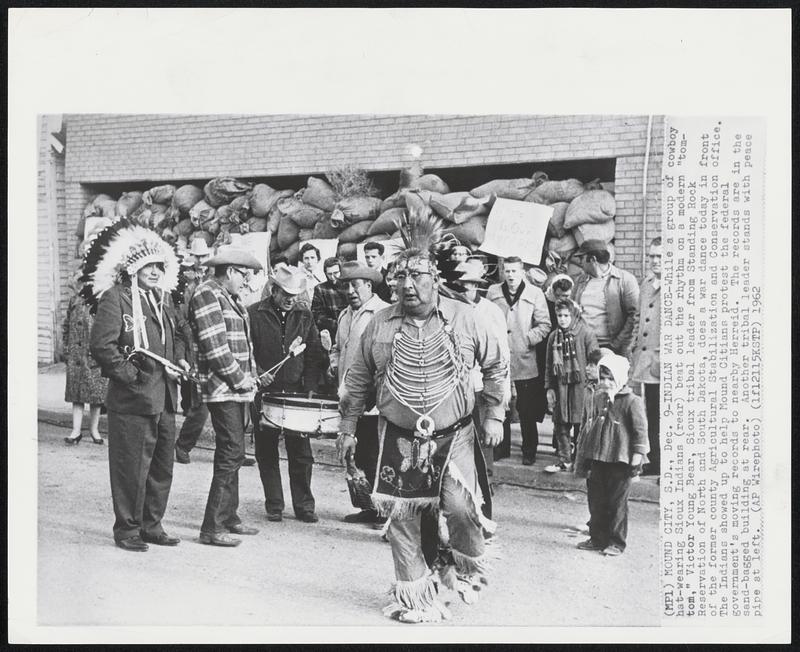 Indian War Dance - While a group of cowboy hat-wearing Sioux Indians ...