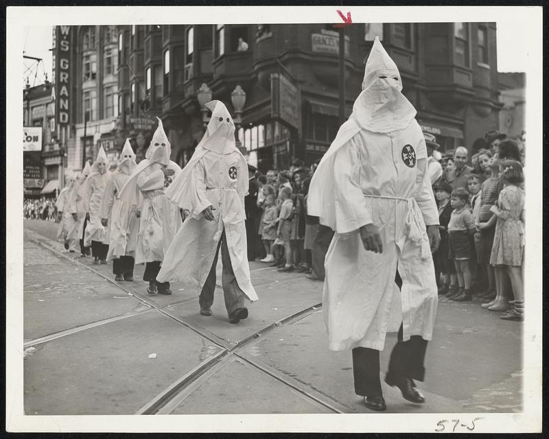 Klansmen on the March Robed and hooded members of the Ku Klux Klan are ...