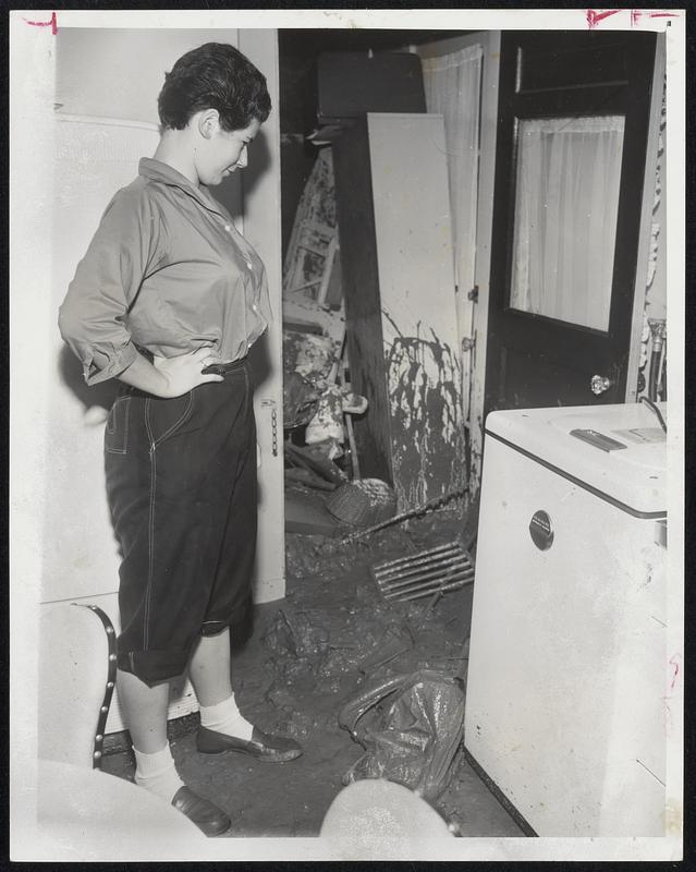 Pretty Mimi Horwitz looks at mud oozing into back porch and kitchen at ...
