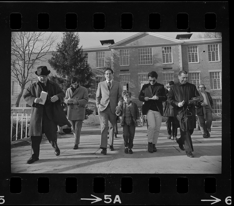 Reporters keep pace with Brandeis University President Morris Abram as ...