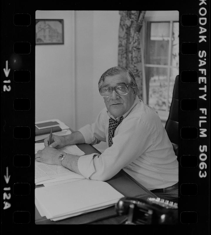 Peter Matthews at desk in office - Digital Commonwealth
