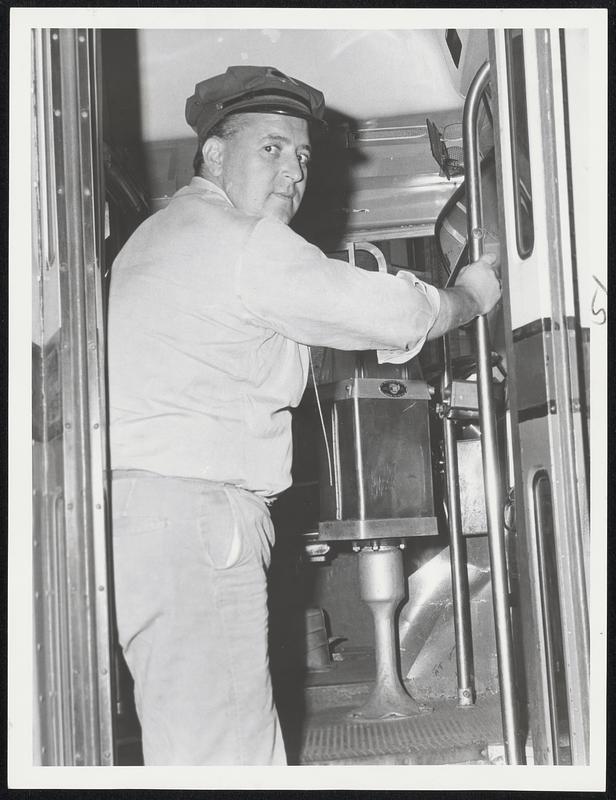 Ready To Roll – Driver Joe Arsenault climbs into cab of his MTA bus ...