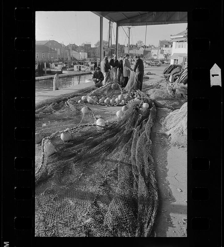 Fish nets laid out to dry on pier, Gloucester, MA - Digital Commonwealth