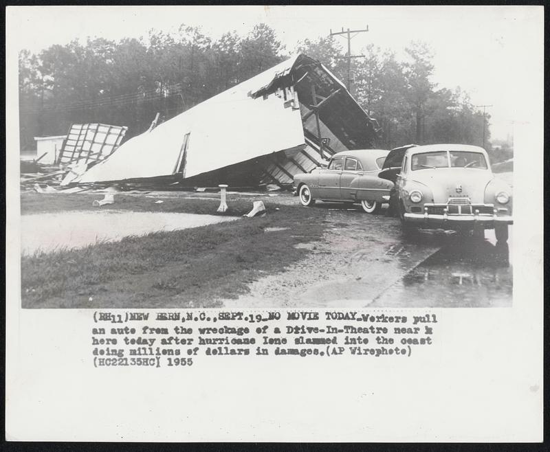 No Movie Today -- Workers pull an auto from the wreckage of a Drive-In ...