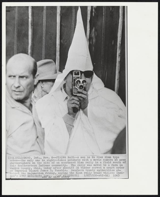 Firing Back--A man in Ku Klux Klan type robes--the only one in sight ...