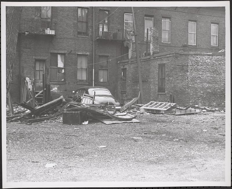 Car surrounded by debris in lot behind building, Boston - Digital ...