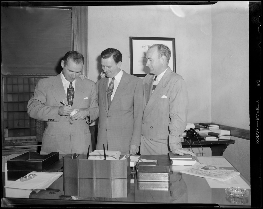 Man signing ball - Digital Commonwealth