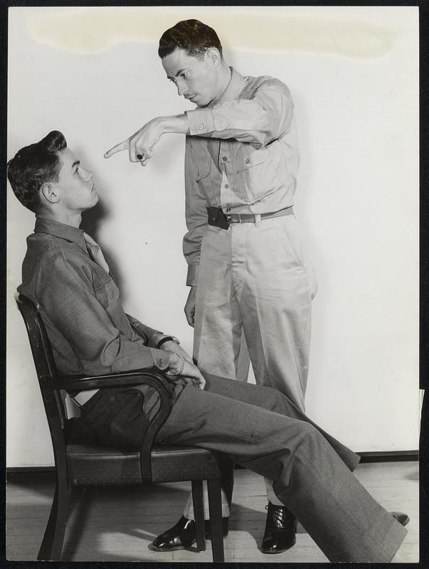 PVT. Lee Burchell of Lowry Field, Colo., a professional magician and ...